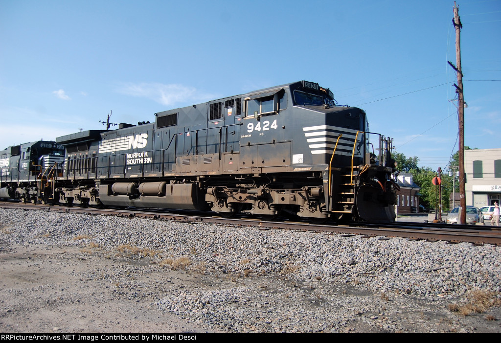 NS C40-9W #9424 is about to cross Main St. with an eastbound